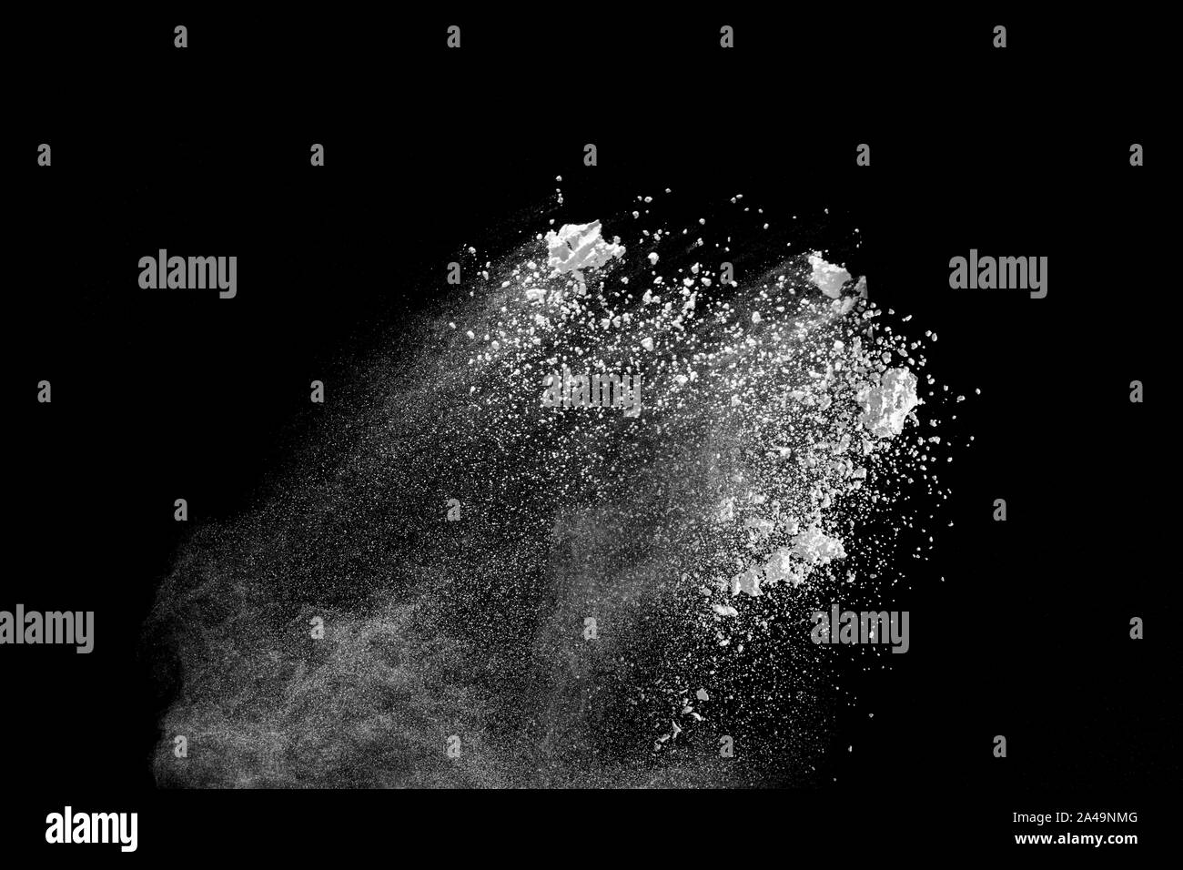 White powder explosion isolated on black background.White dust ...