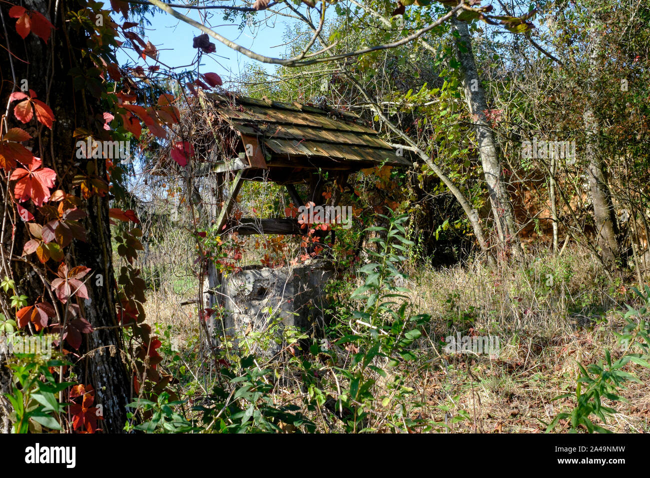 old derelict traditional water well standing isolated in a large area ...