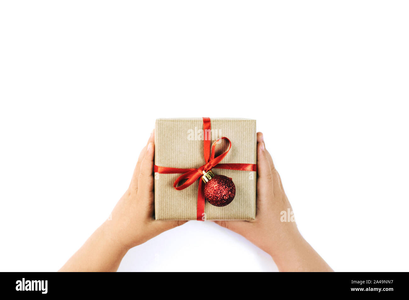 Child's hands holding gift box isolated on white background. Flat lay ...