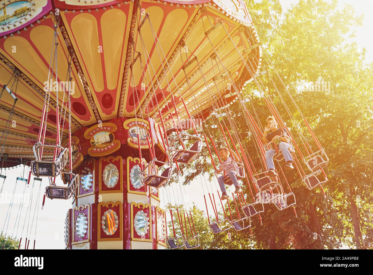 Chain carousel merry-go-round in amusement park Stock Photo - Alamy
