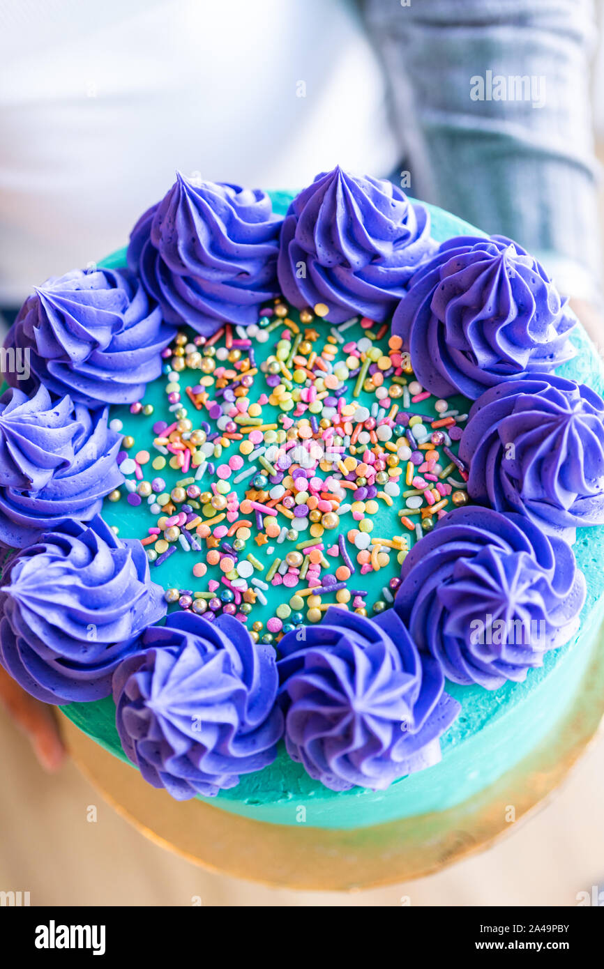 Birthday cake with turquoise buttercream and purple rosettes and ...
