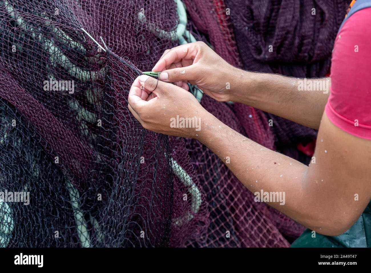 Commercial fisherman mending nets hi-res stock photography and images ...