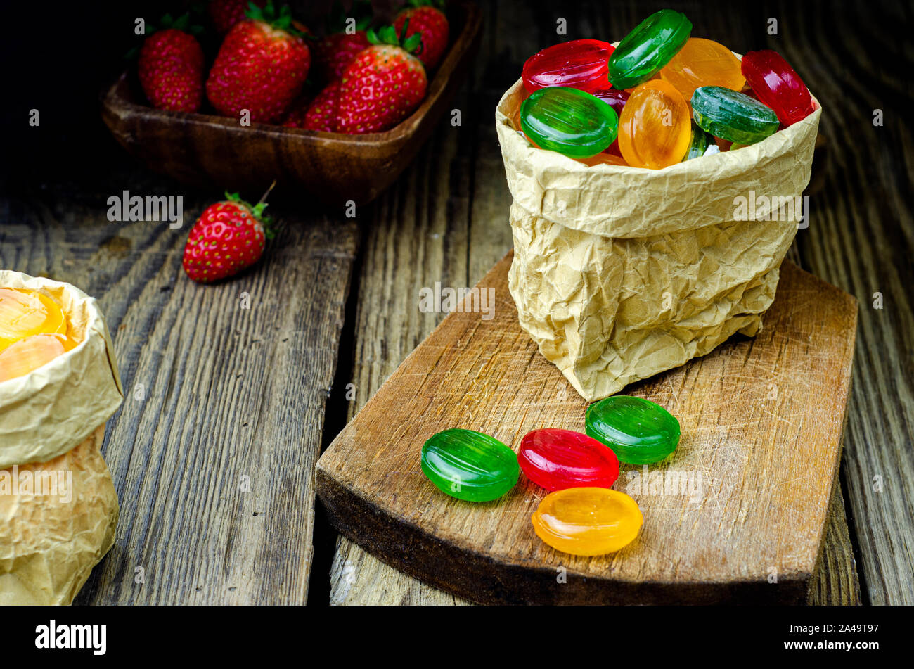 Many assorted sweet sugar candies on vintage wooden background Stock ...