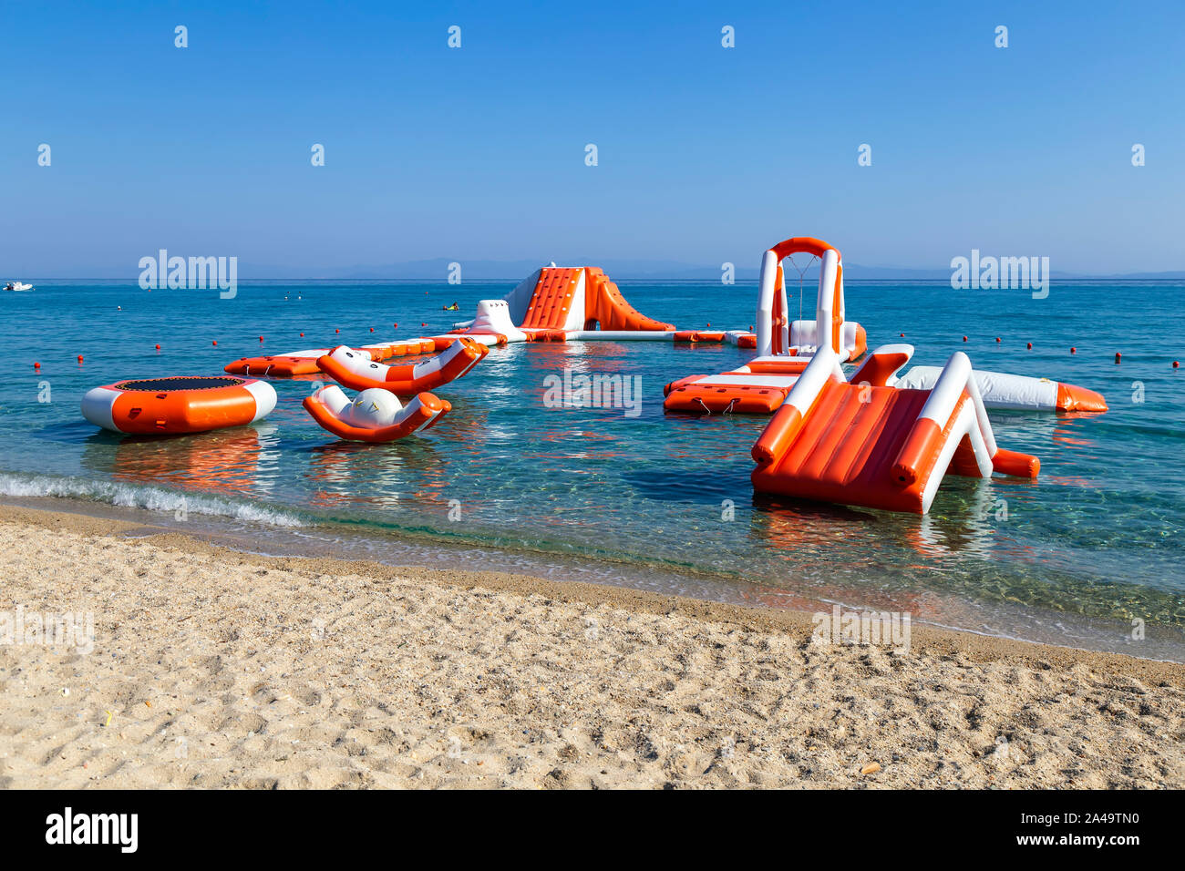 Inflatable floating slider water park. Water outdoor bouncy park ...