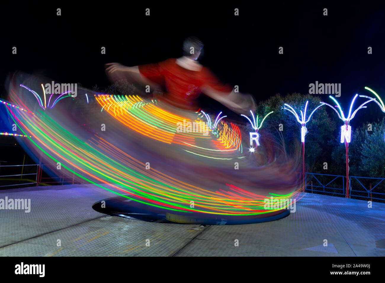 Mechanical ballerina ride at night. Ballerina fun with illumination ...