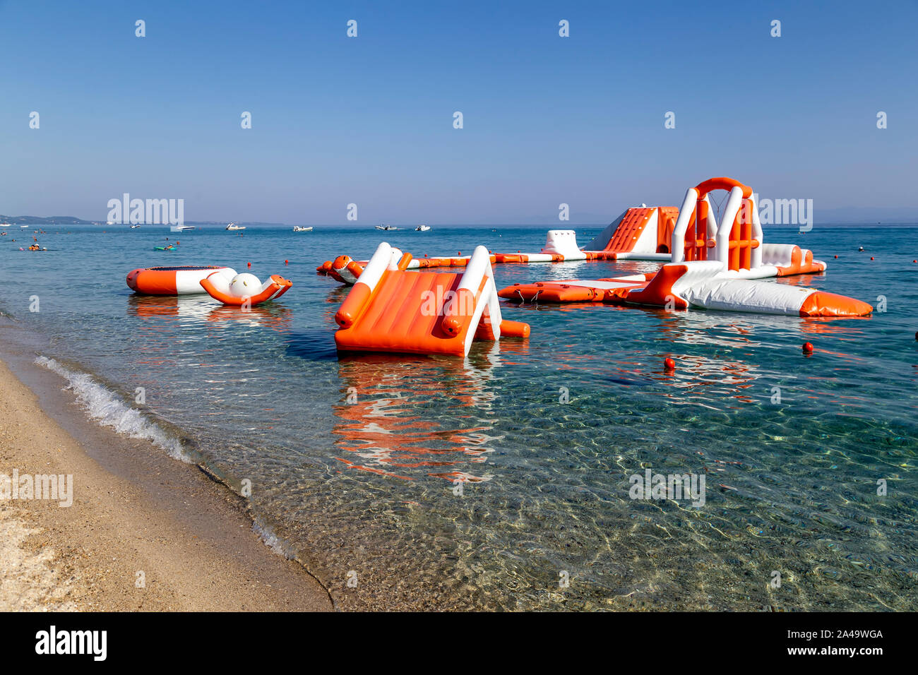 Inflatable floating water park. Water outdoor bouncy park, floating ...