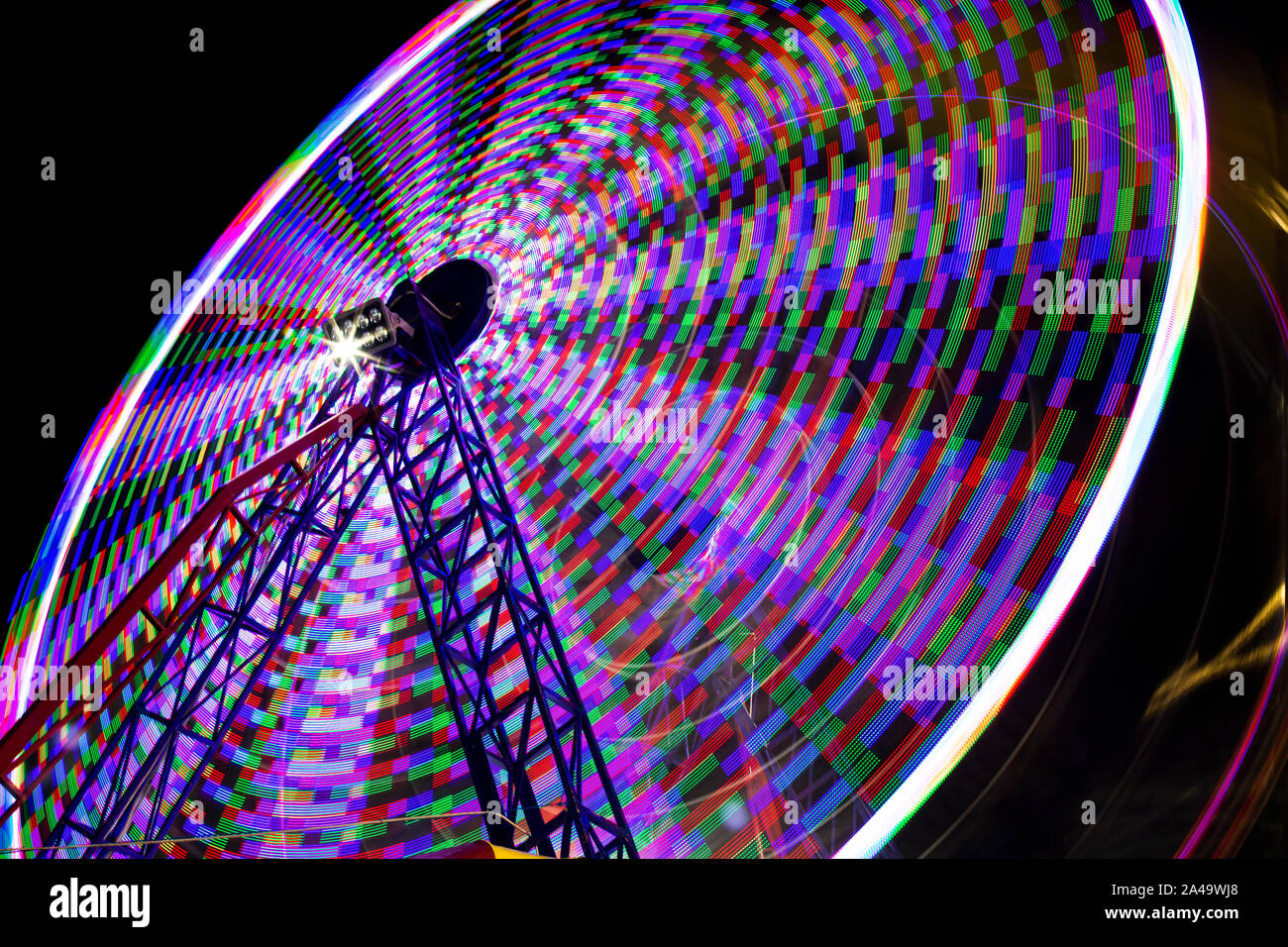 Centrifuge wheel moving at night. Wheel fun with illumination against ...