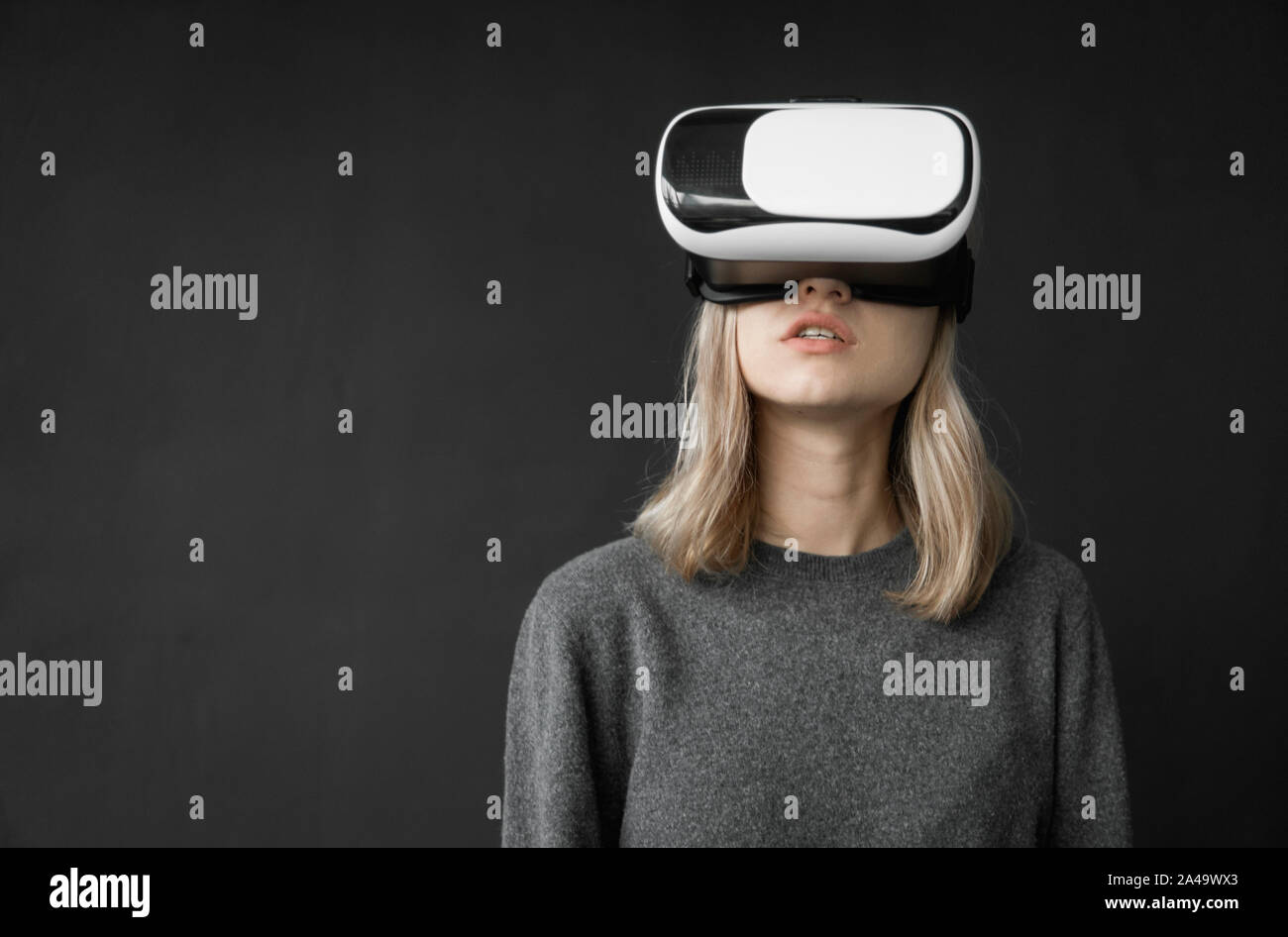 Young woman wearing virtual reality goggles headset, vr box. Connection ...