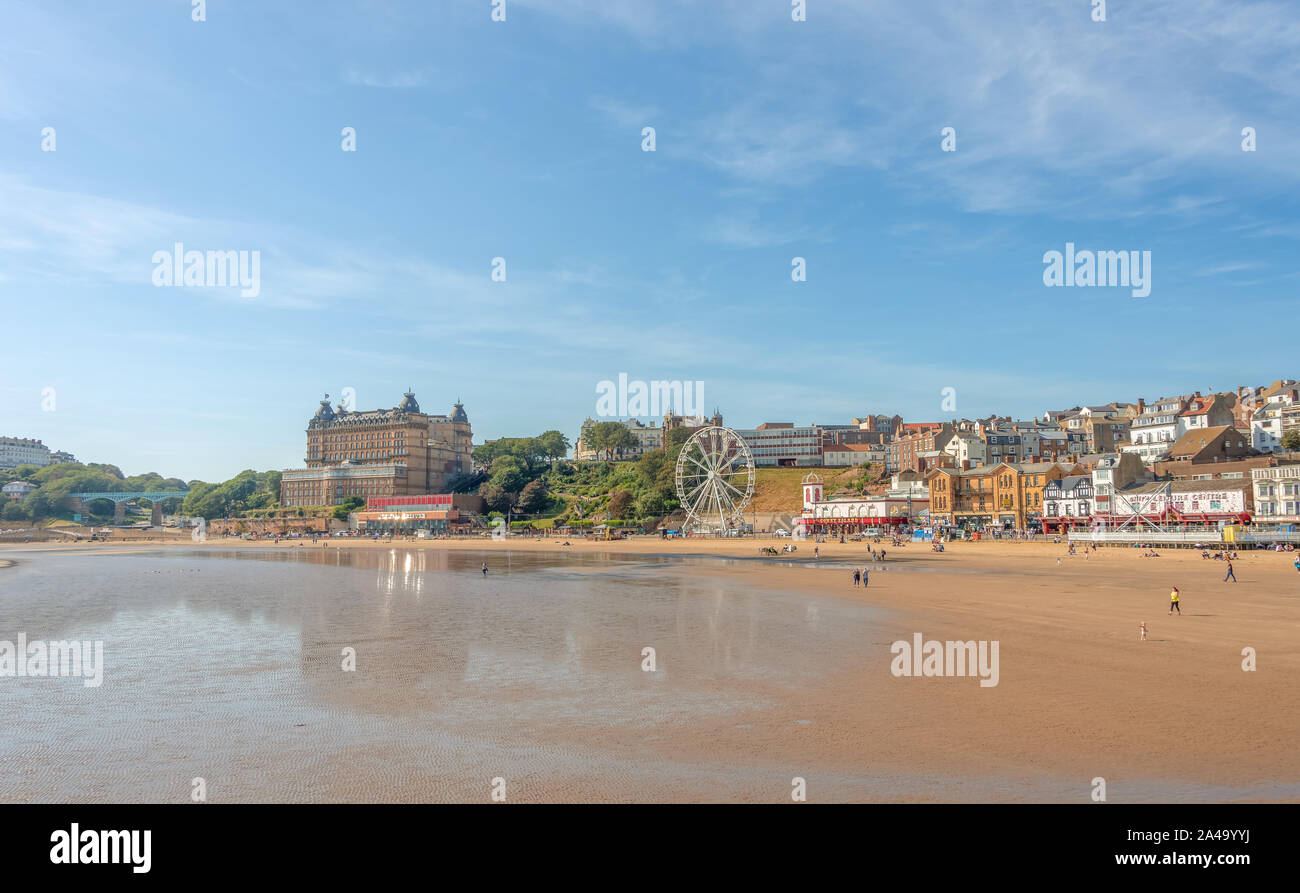 People enjoy the sunshine on the beach at Scarborough in late summer. A ...