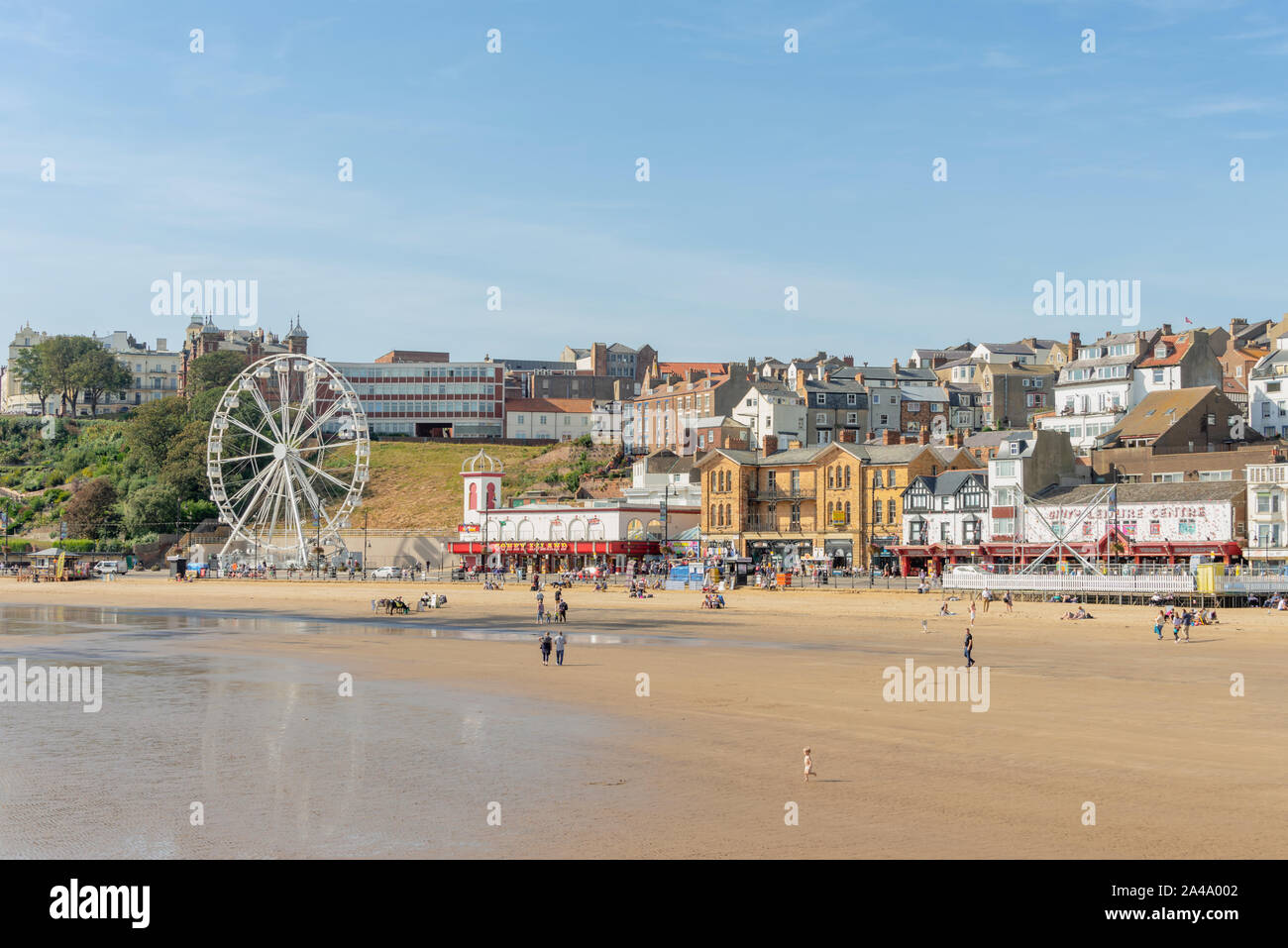 People enjoy the sunshine on the beach at Scarborough in late summer. A ...