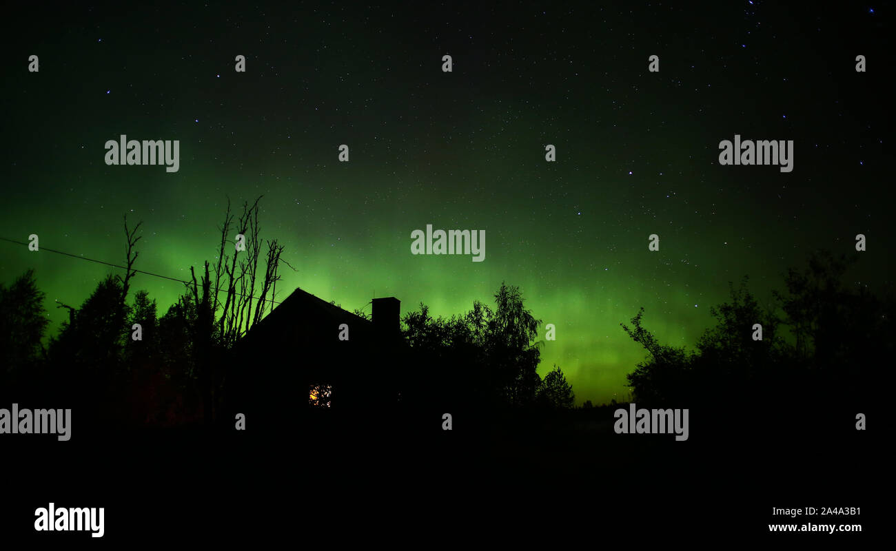 Northern lights over house in the night Stock Photo - Alamy