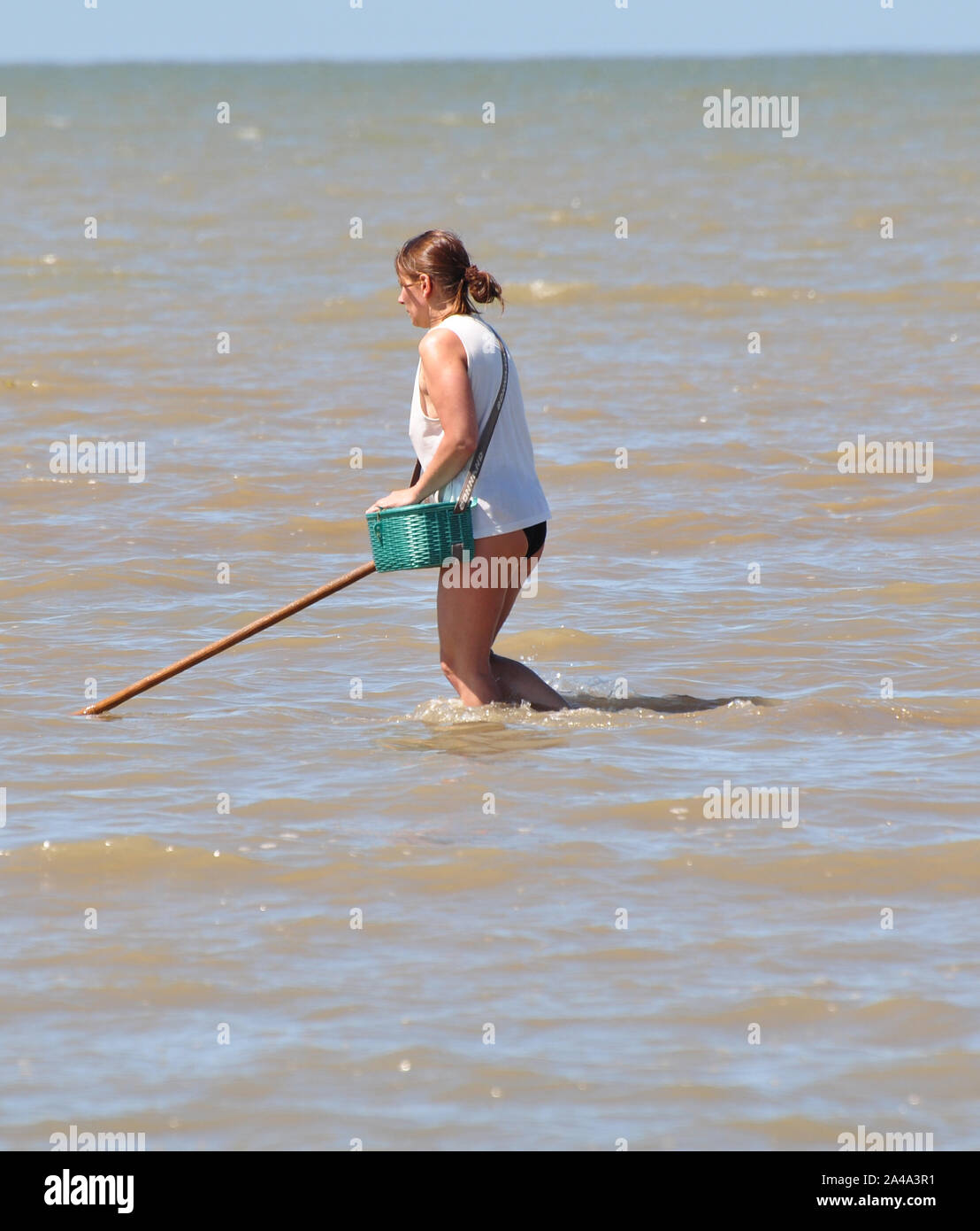 Woman fishing with net beach hi-res stock photography and images - Alamy