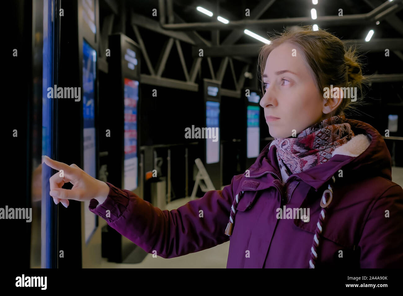 Woman using interactive touchscreen display of electronic multimedia ...