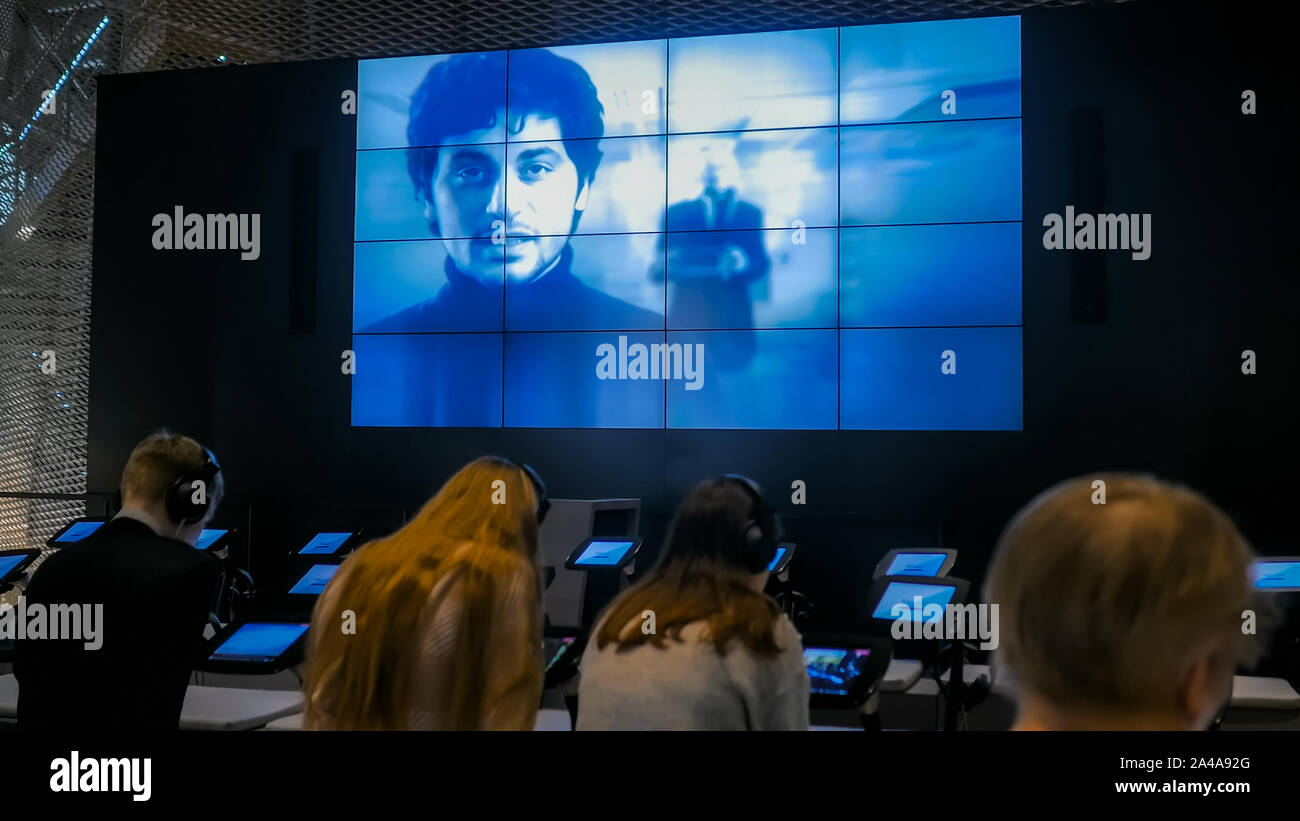 Group of students watching video presentation about tolerance on large ...