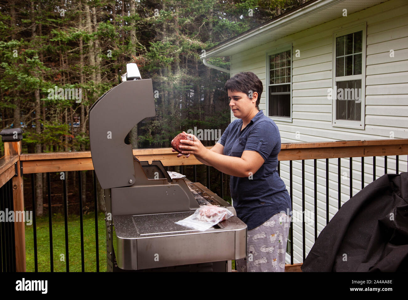person bbq'ing their hamburger meat on the deck Stock Photo - Alamy