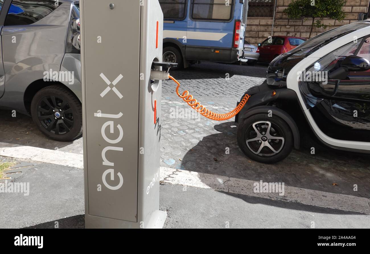 An electric car being recharged at a street charging station Stock ...