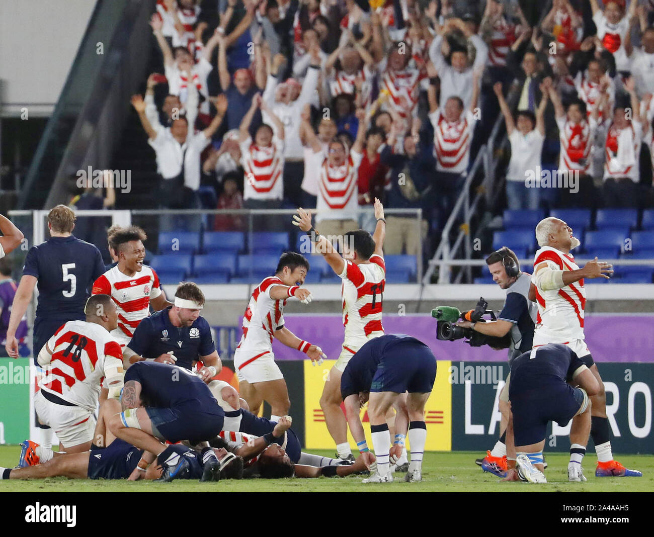 Japan players celebrate after beating, UK. , . in Yokohama, near Tokyo ...
