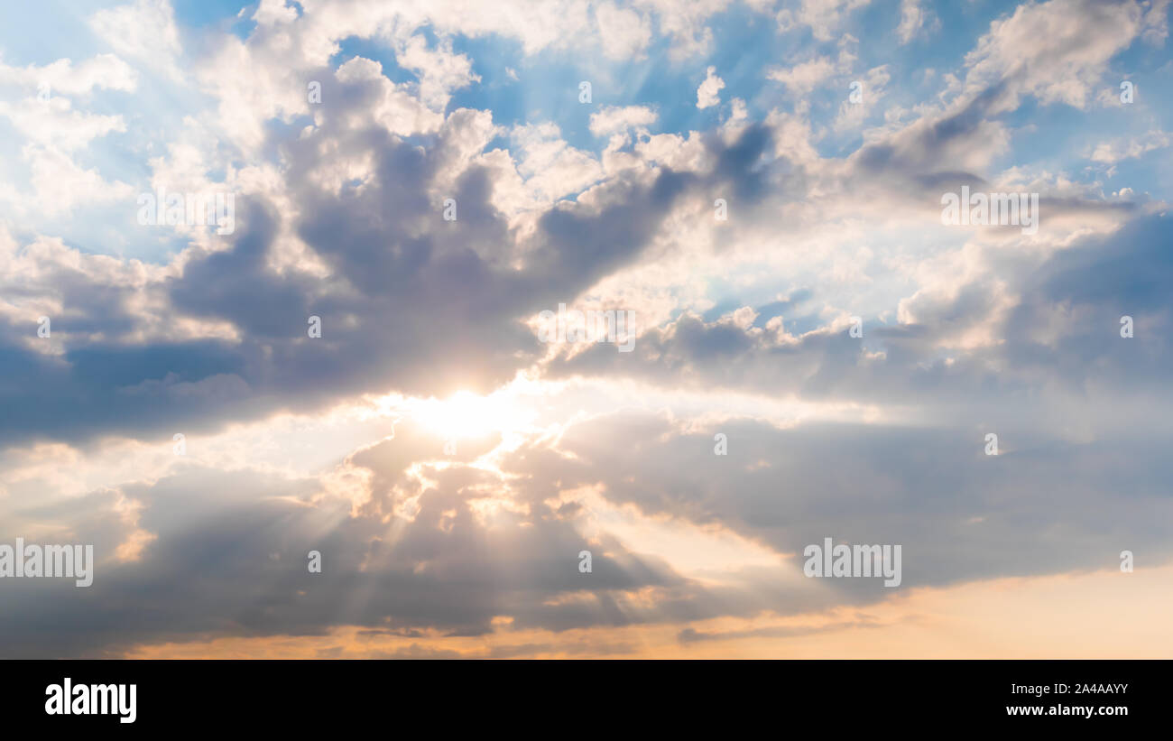 Sun beams shining through dramatic white clouds, hope and religion ...