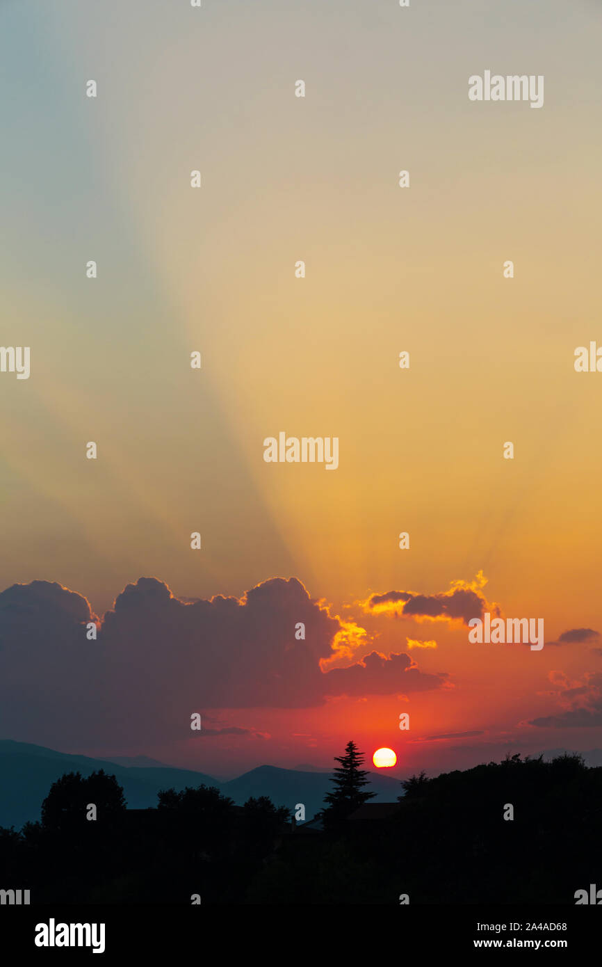 Landscape at twilight, dramatic sunset, cloudy weather with sunlight ...