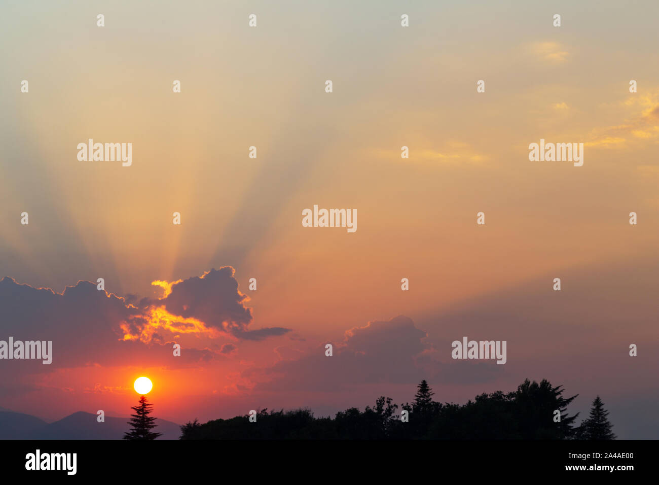 Landscape at twilight, dramatic sunset, cloudy weather with sunlight ...