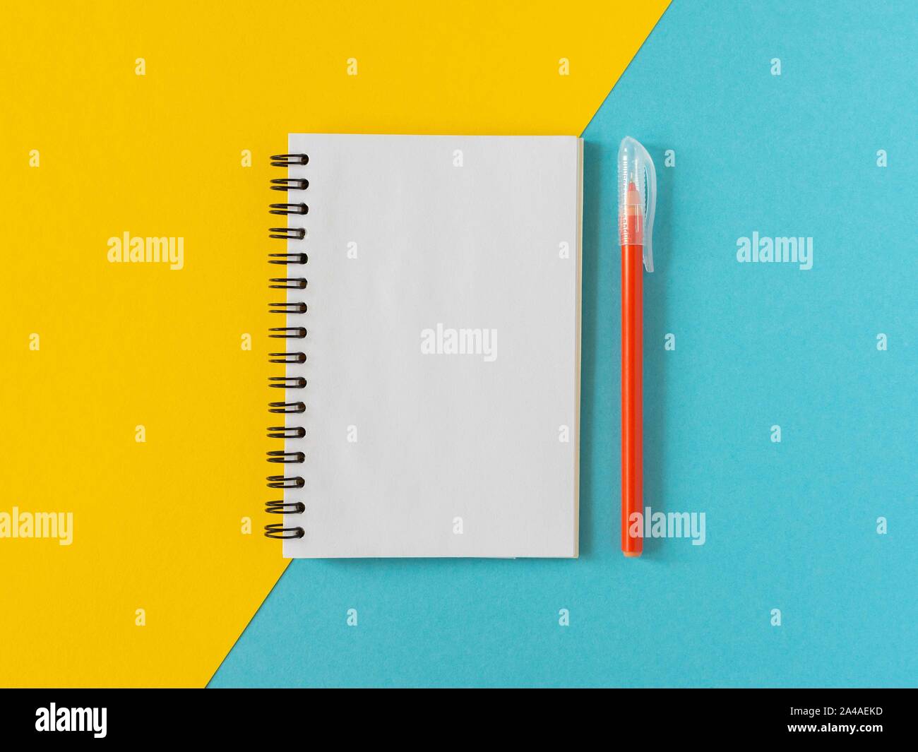 Open spiral notepad on colored background , notebook and pen lie on ...