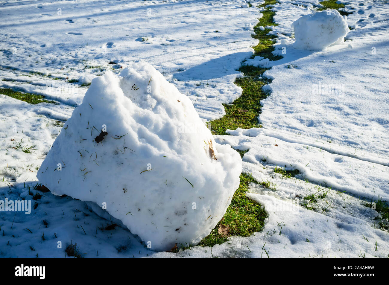 A lump of snow rolled down a hill and a footpath appeared with green ...