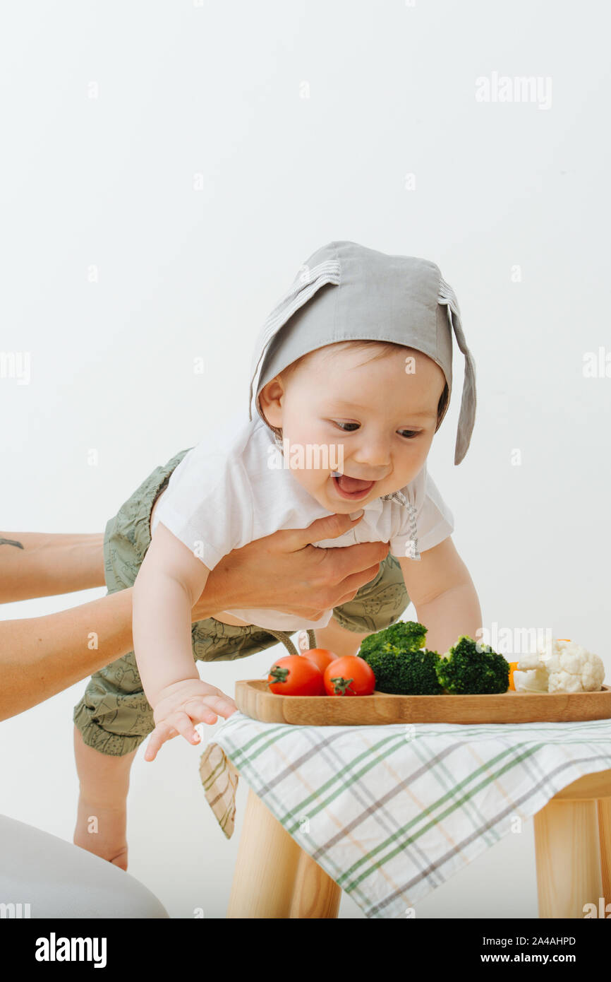 Active restless infant child is presented food Stock Photo - Alamy