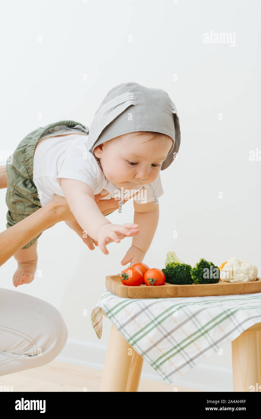 Active restless infant child is presented food Stock Photo - Alamy