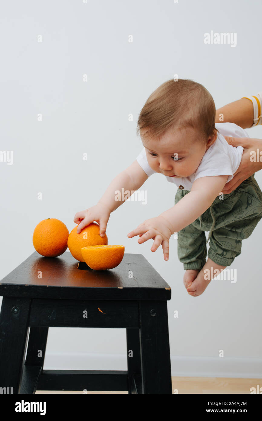 Image of Little boy grabbing juicy fruits Stock Photo - Alamy