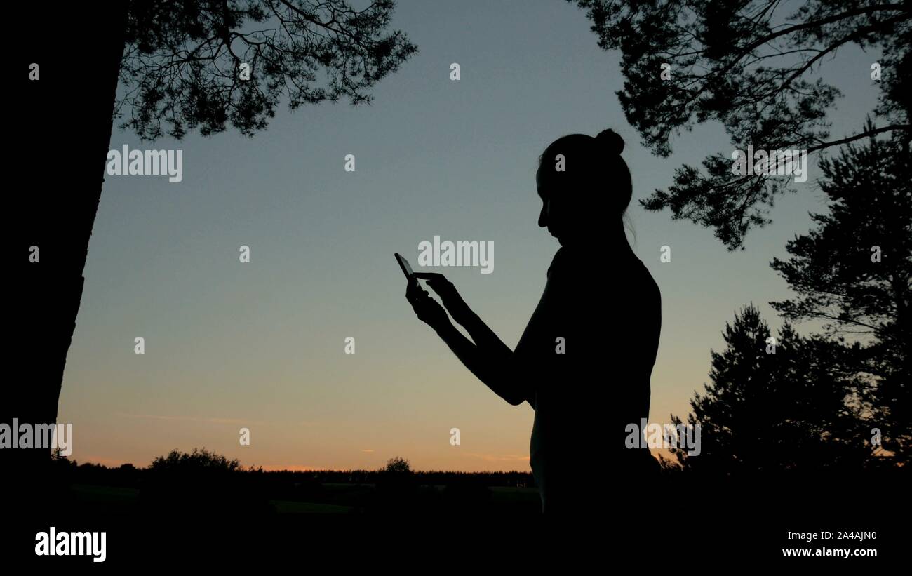 Silhouette woman using cell hi-res stock photography and images - Alamy