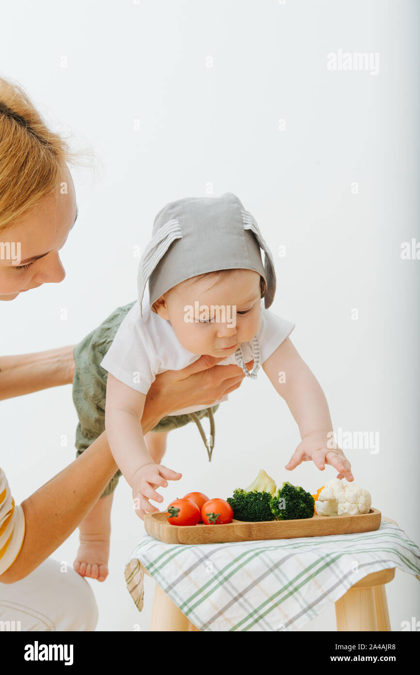 Active restless infant child is presented food Stock Photo - Alamy