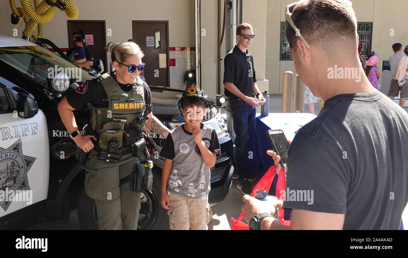 A friendly female police officer interacts with the public at fire ...