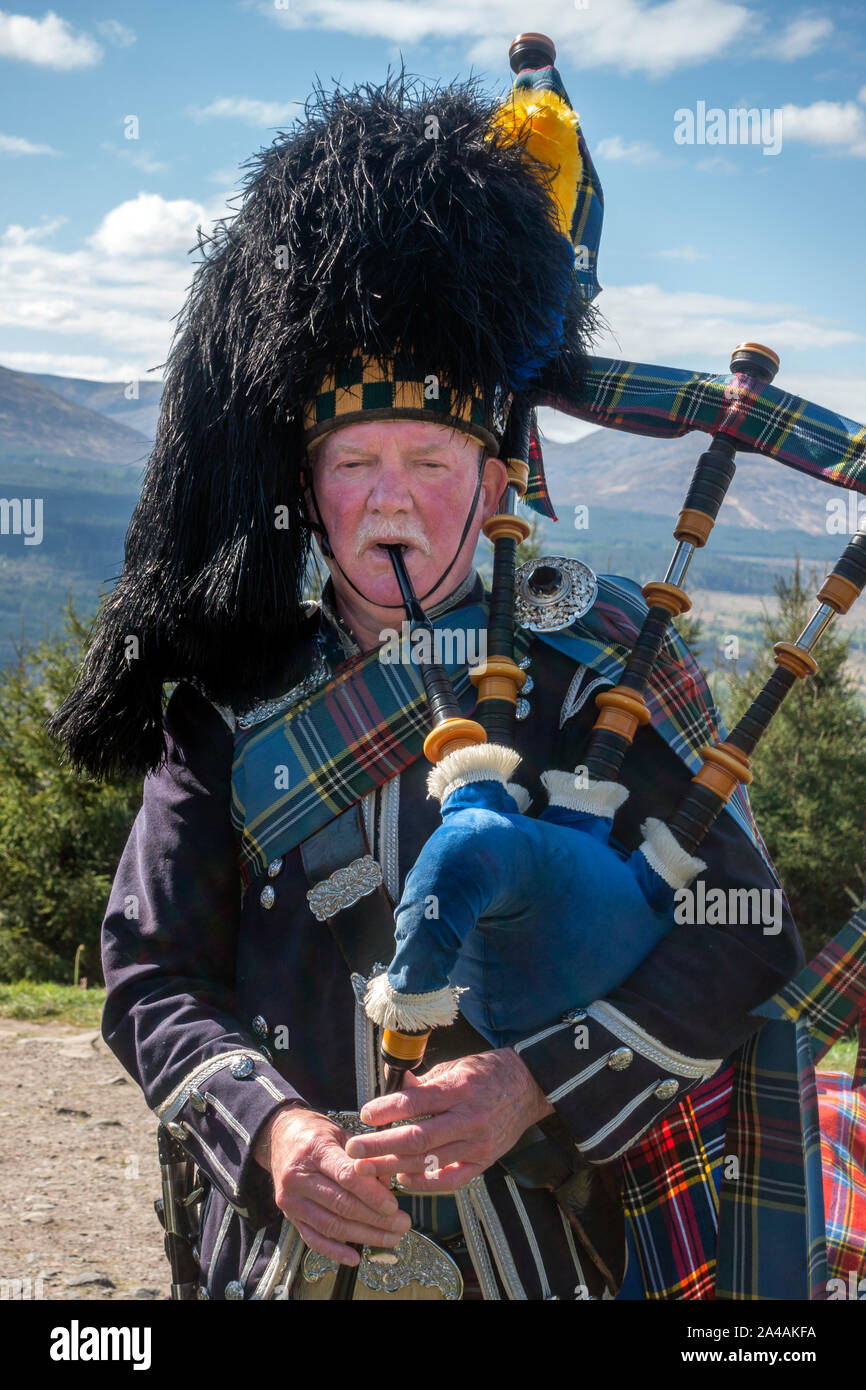 Scottish loch with piper hi-res stock photography and images - Alamy