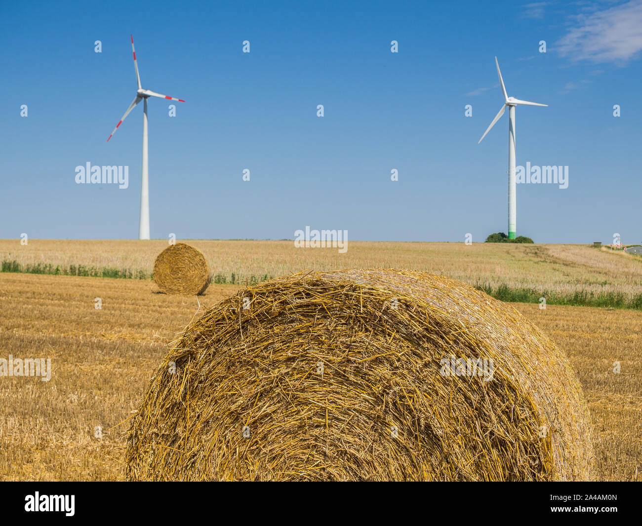 Straw bale with wind turbines Stock Photo - Alamy