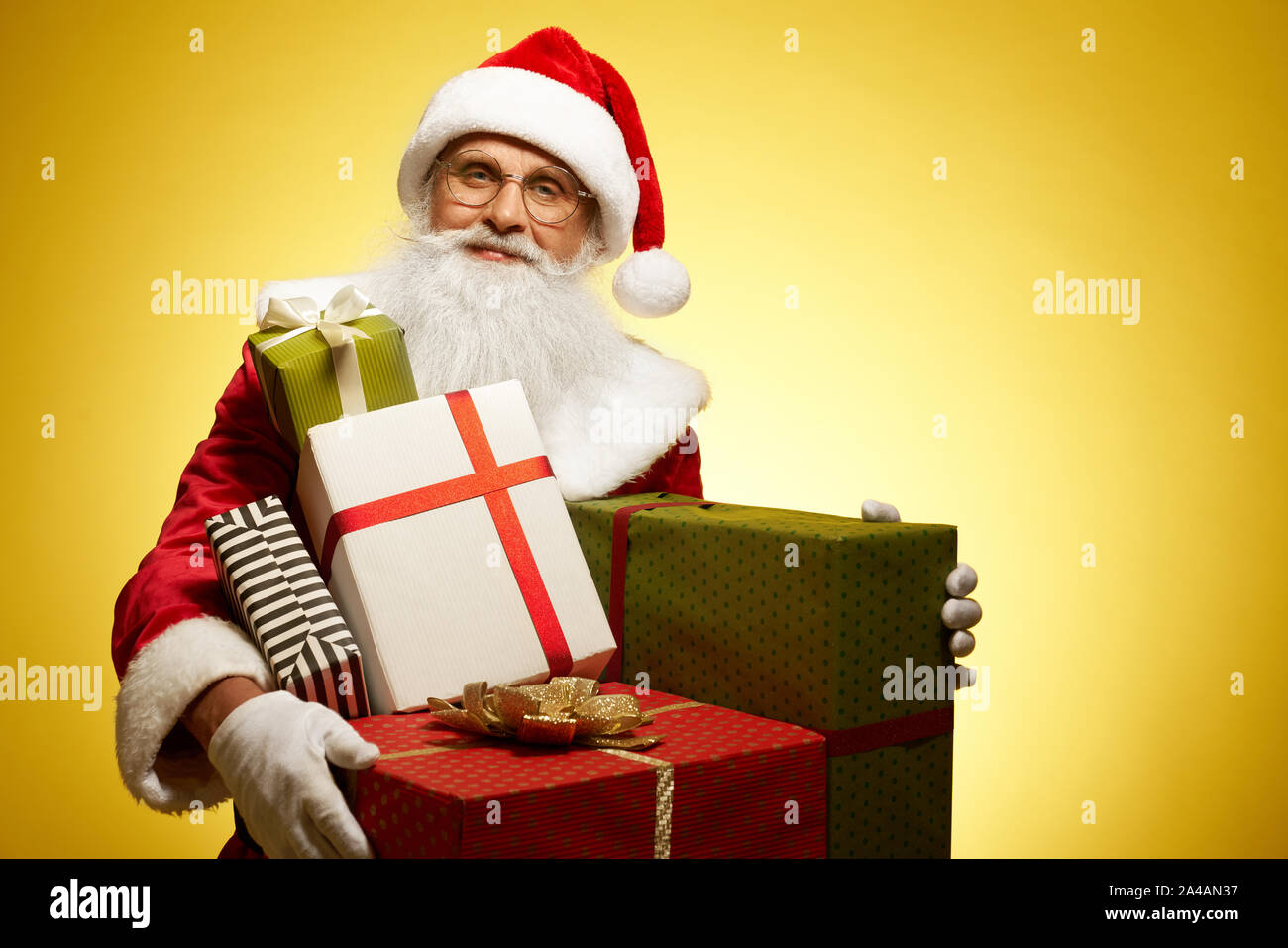 Friendly aged Saint Nicholas with real grey beard in eyeglasses and ...