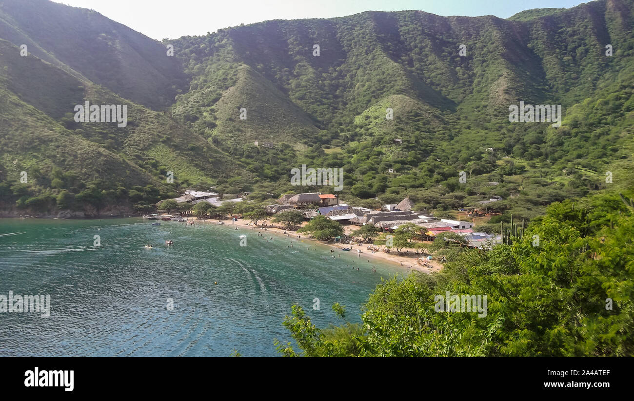 Aerial view of Colombian beach with small town over Caribbean sea bay ...