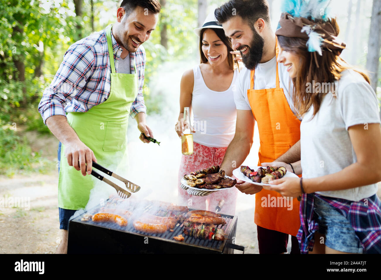 Friends having fun in nature doing bbq Stock Photo - Alamy