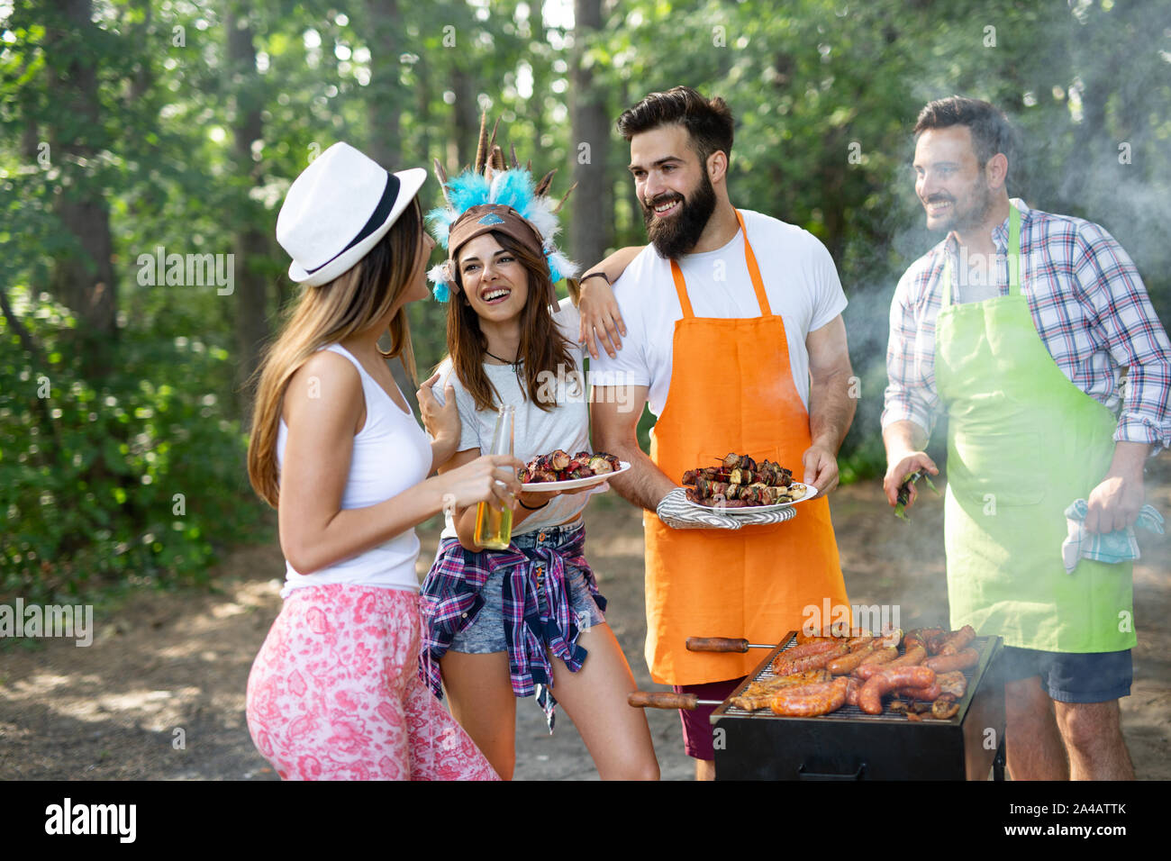 Group of happy young friends having barbecue party, outdoors Stock ...