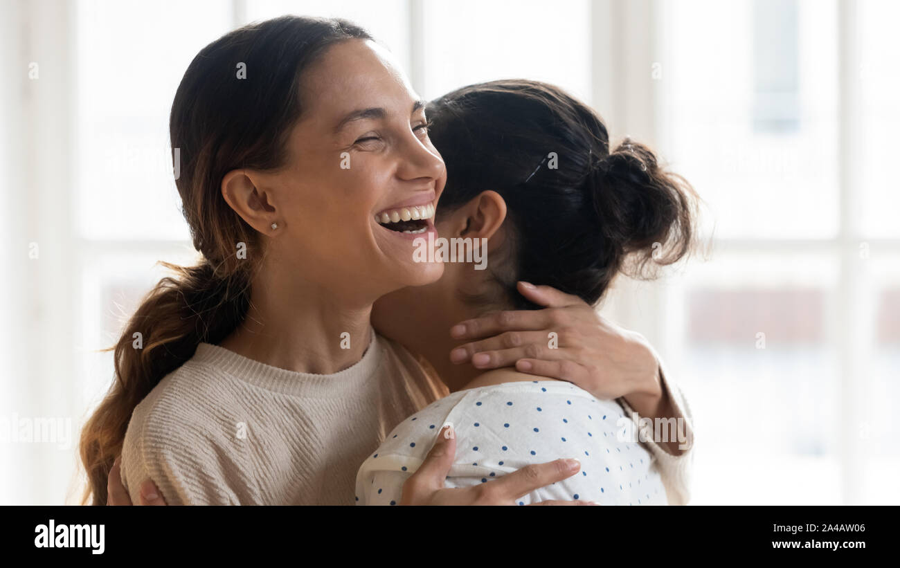 Excited diverse best friends embracing and laughing close up Stock ...