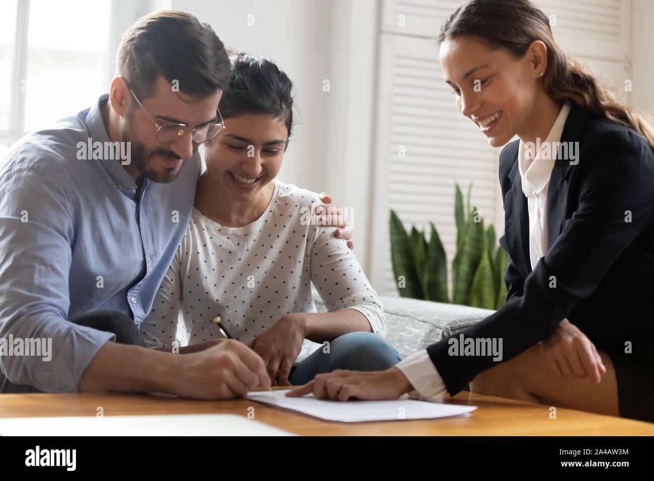 Happy married diverse couple signing contract, making legal deal Stock ...