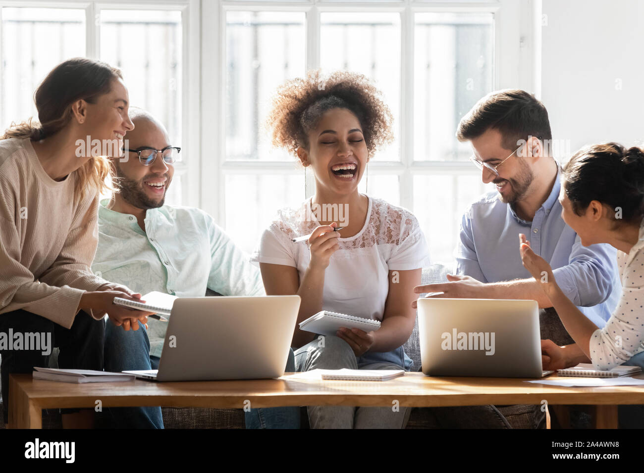 Happy diverse students having fun, laughing at joke, studying together ...