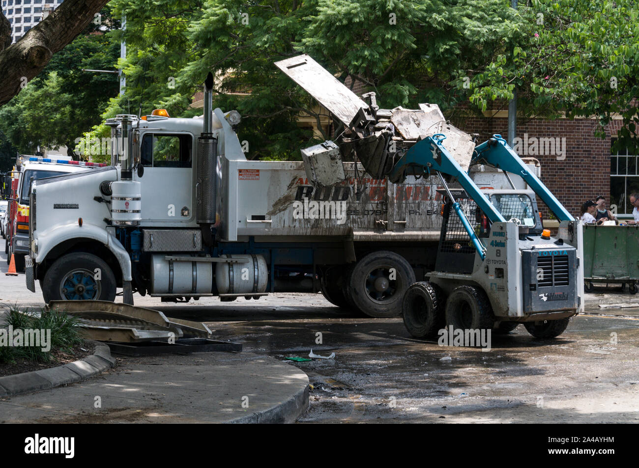 A forklift truck loading flood damaged equipment onto a waiting ...