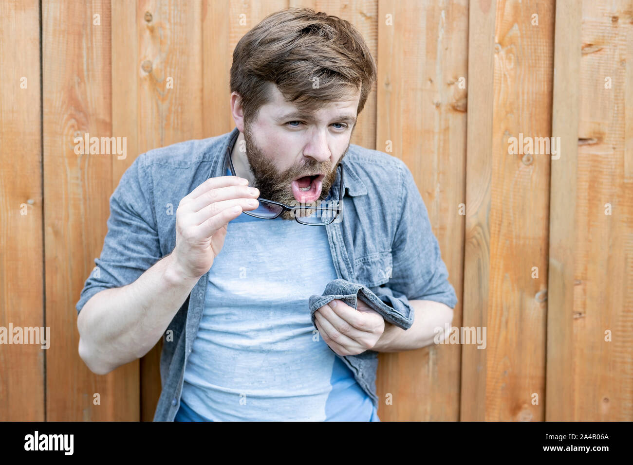 Man wiping face shirt hi-res stock photography and images - Alamy