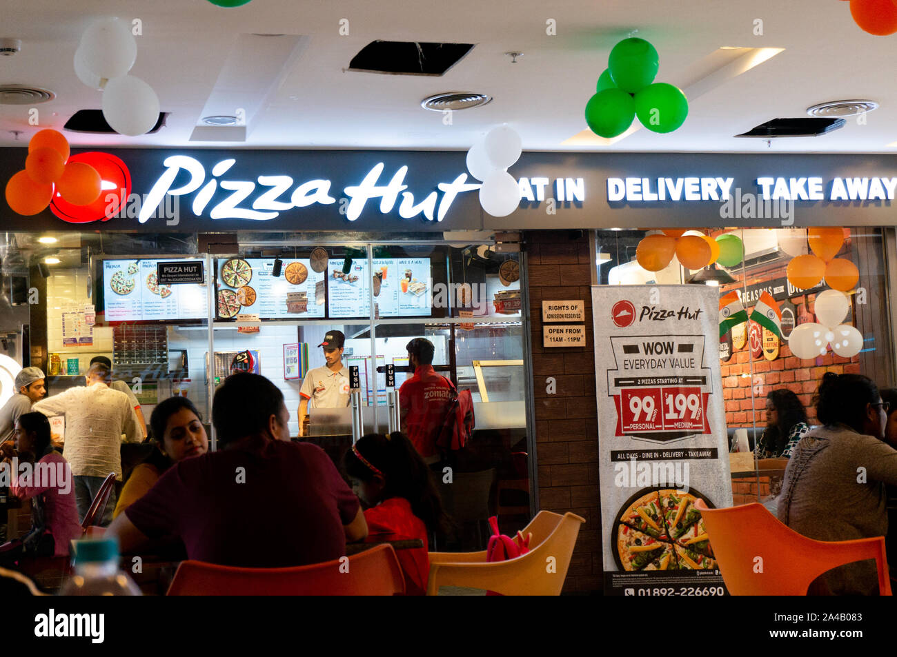 Crowd of people sitting outside a pizza hut store in India asia Stock ...
