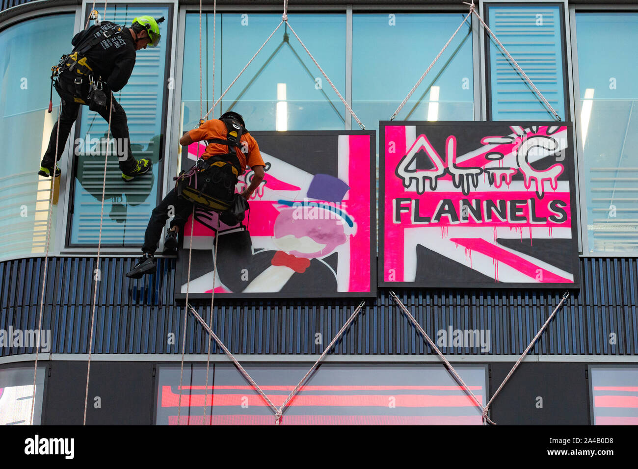 Street artist Alec Monopoly abseils down the Flannels store on Oxford ...