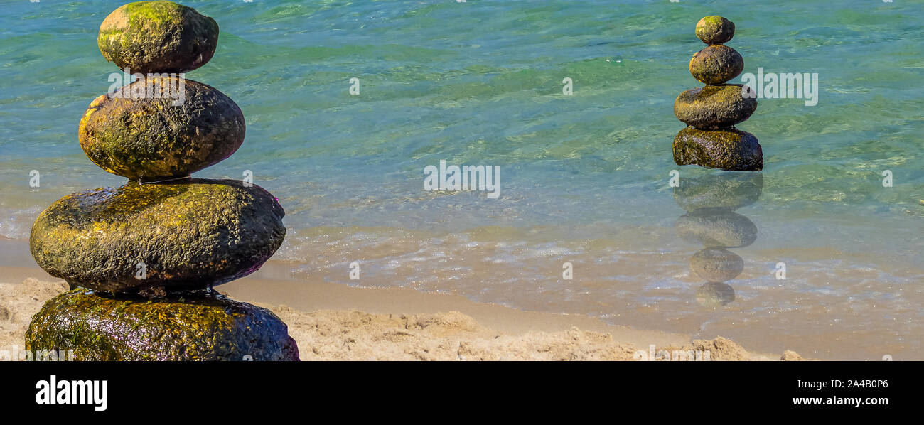 Panorama Stones of balance on the beach Stock Photo - Alamy