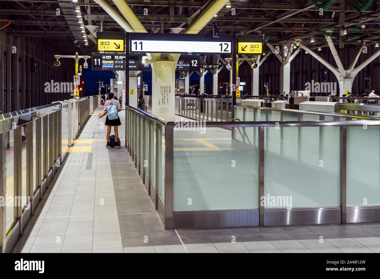 TOKYO, JAPAN - OCTOBER 5, 2018. School Girl Is Waiting For A Shinkansen ...