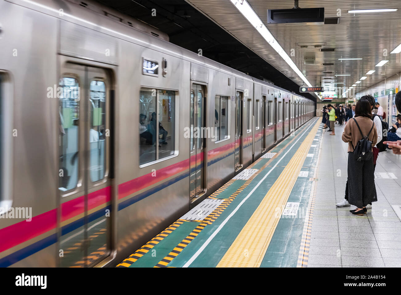TOKYO, JAPAN - OCTOBER 6, 2018. Train Is Arriving To The Platform At ...