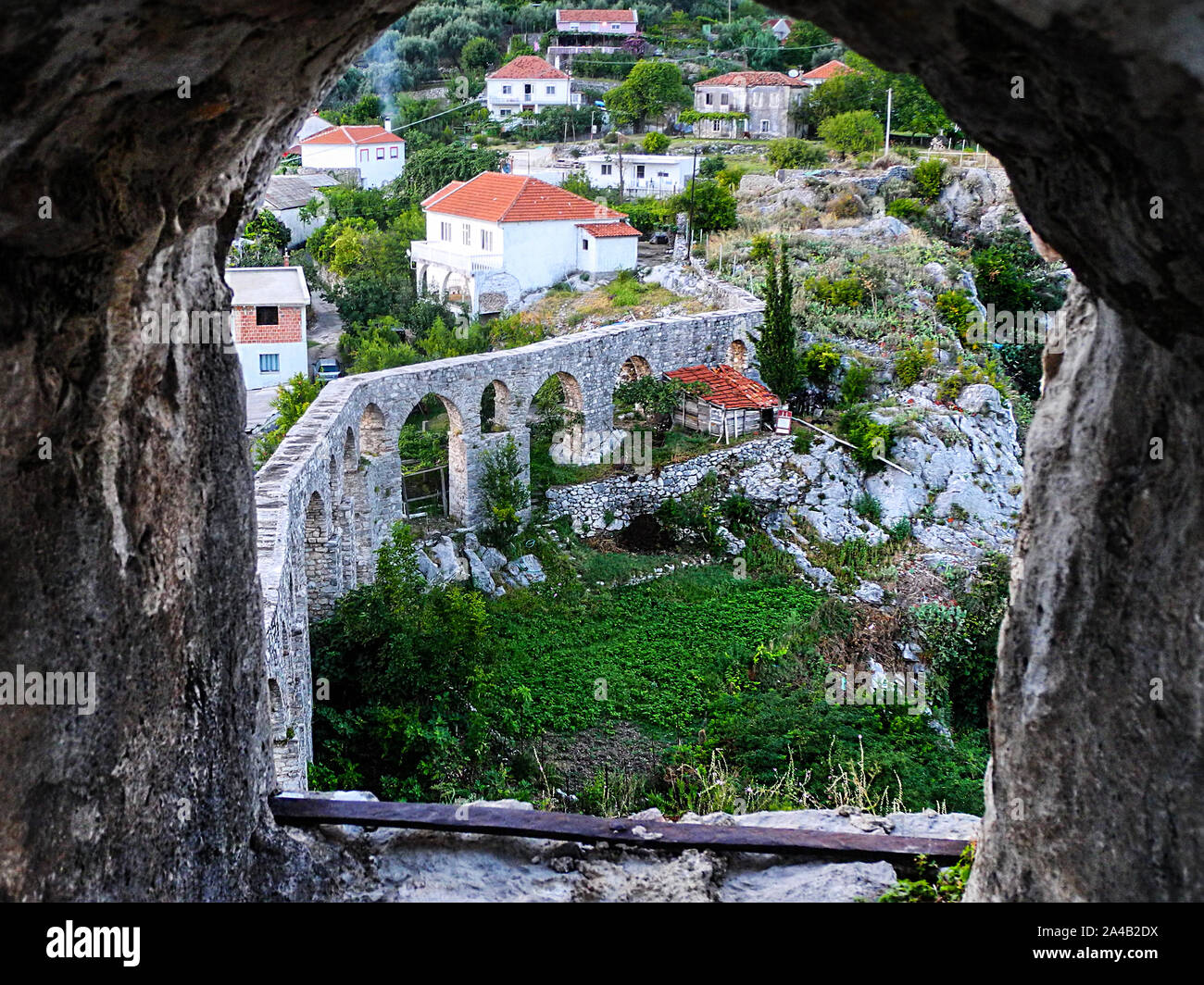 Top view through arch (through window) to the ancient old aqueduct ...