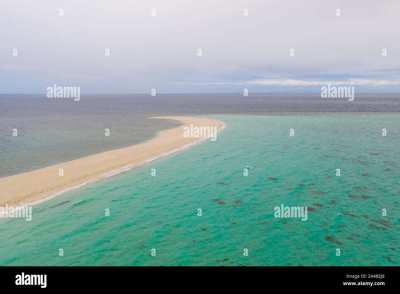 Sand beach island on a coral reef, top view. Atoll with an island of ...
